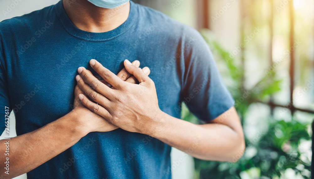hand over chest, depicting heart attack pain, against a clean ...
