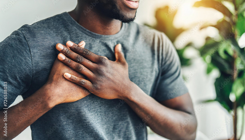 hand over chest, depicting heart attack pain, against a clean ...