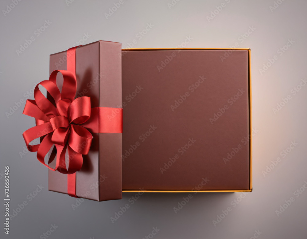 Sophisticated open brown gift box with a luxurious red ribbon, set on a ...