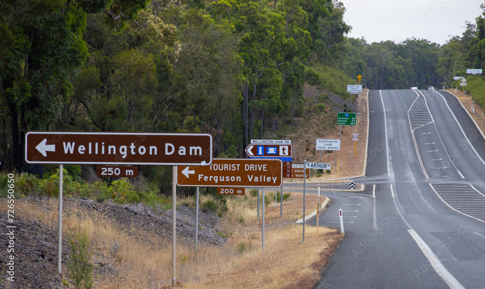 lots of road signs on side of highway at the Wellington Dam turn off ...