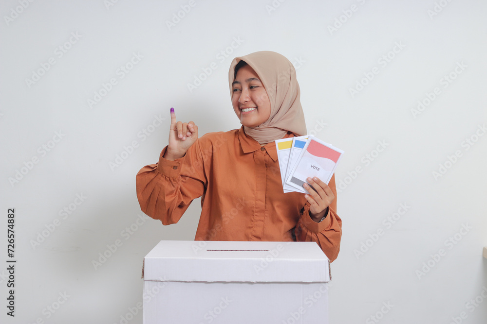 Portrait of Asian hijab woman showing the little finger dipped in ...