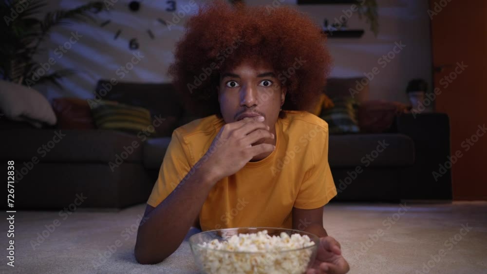 POV of a young African American man lying on the carpeted floor ...
