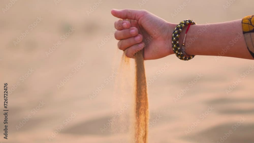 Close up shot of hand pouring desert sand at Khuri sand dunes in Thar ...