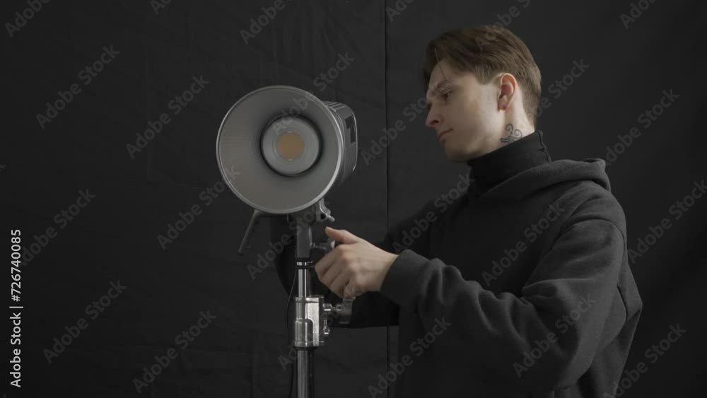 The lighting engineer sets up and adjusts the lighting in the studio ...