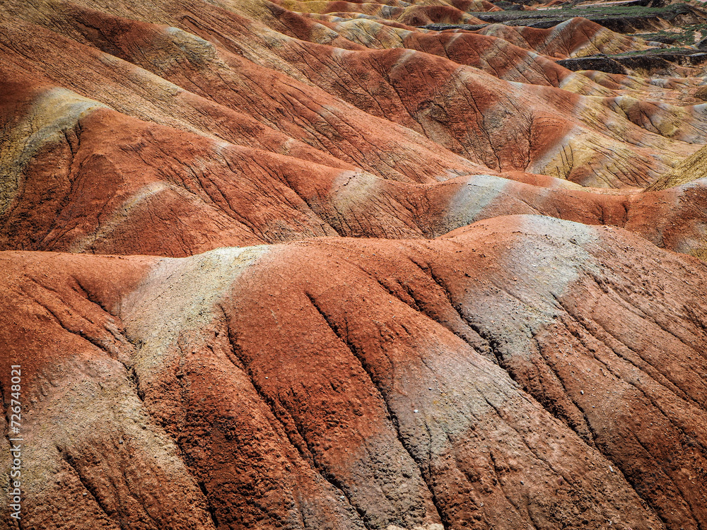 Strata in sedimentary rock formation with alternating red, grey and ...