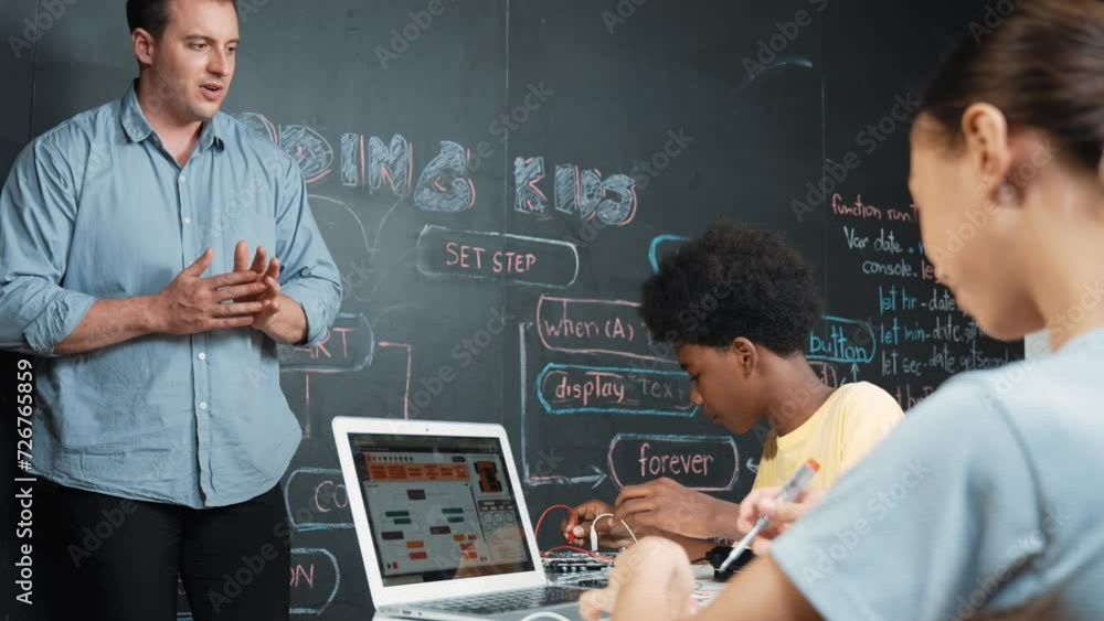 Teacher teaching about coding system while diverse academic student ...