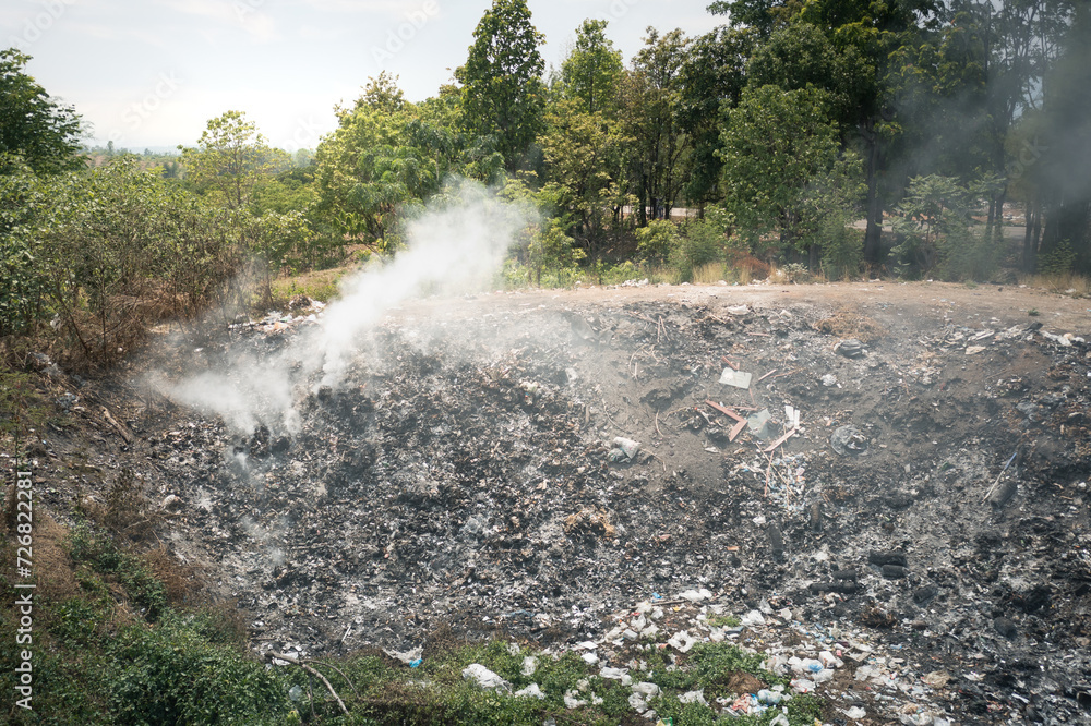 Garbage, fire burning and smoke in landfill. Also called trash, waste ...