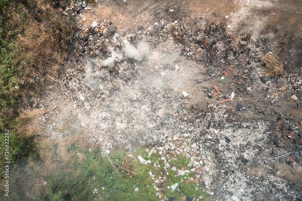 Garbage, fire burning and smoke in landfill. Also called trash, waste, rubbish. Destruction with ...