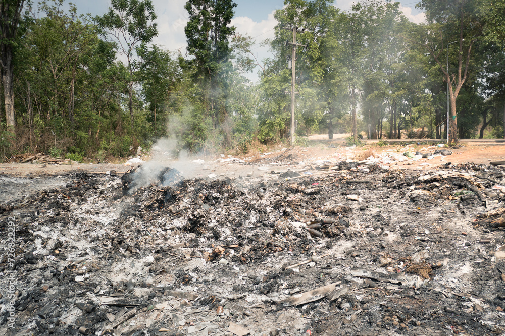 Garbage, fire burning and smoke in landfill. Also called trash, waste ...