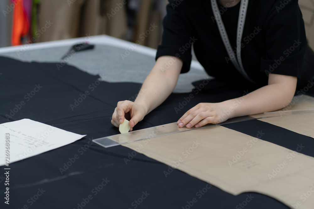 transfering clothes paper patterns onto fabric in the wear workshop ...