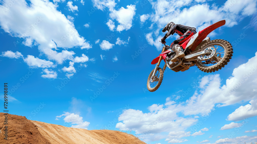 A thrilling scene unfolds as an off-road motocross bike defies gravity ...