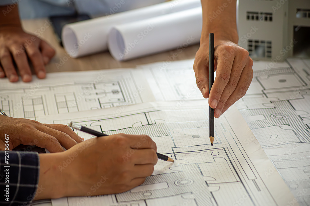 Professional cartographers working with cadastral map at table, closeup ...