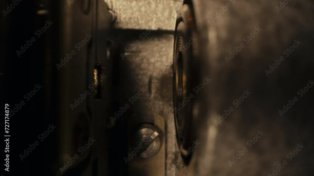 Powerful light bulb illuminates each frame of film reel. Shutter ...