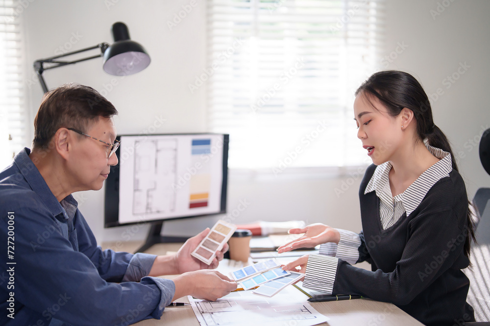 Interior designer women explaining blueprint of construction ...