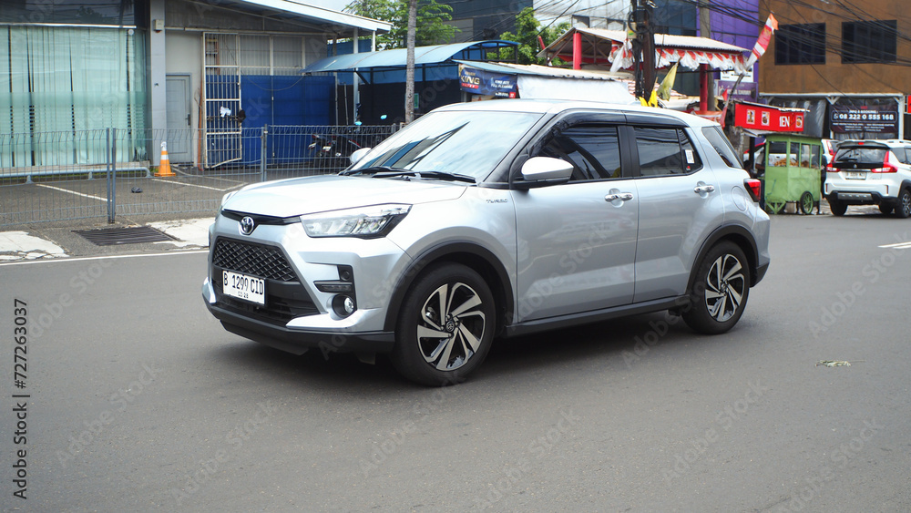 White Toyota Raize car, driving in commercial area, Radio Dalam Street ...