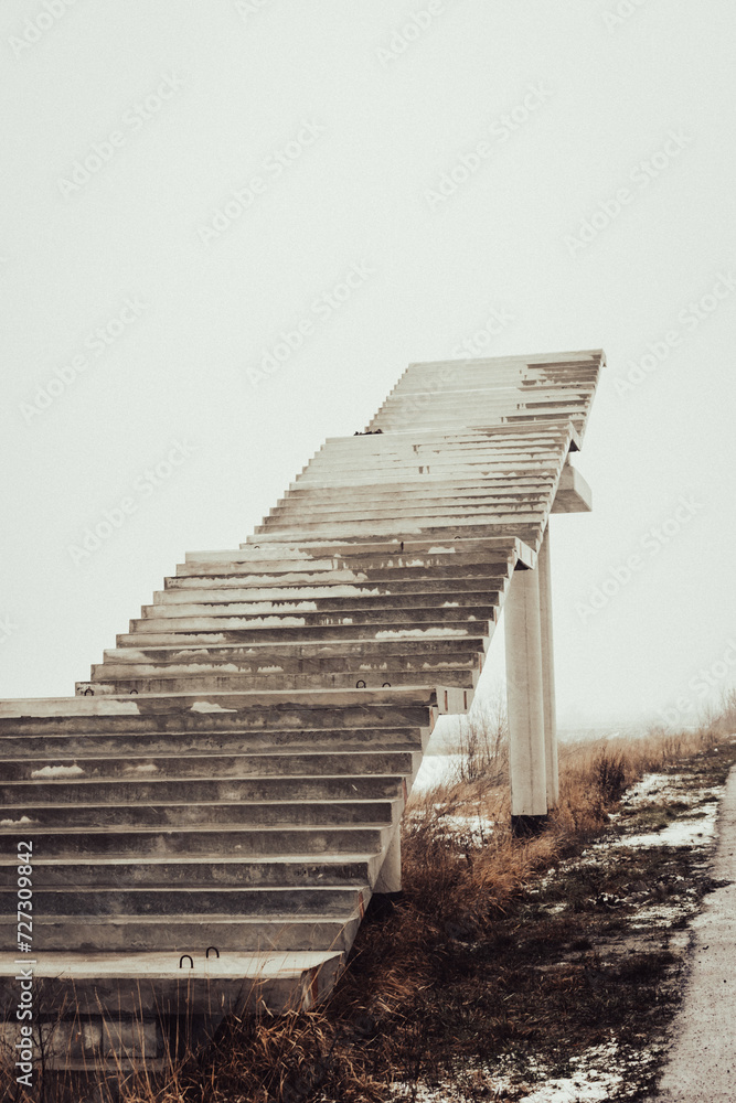 Stairs to nowhere. Empty unfinished bridge. Outdoor staircase without ...