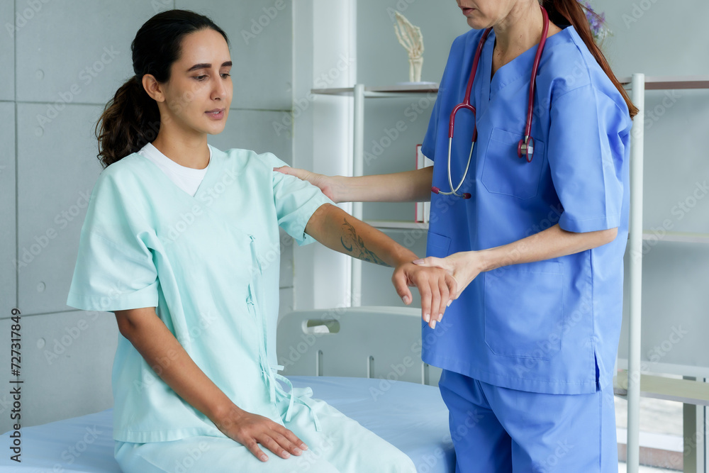female therapist offers a reassuring touch to patient's arm, expertise evident in the clinical ...