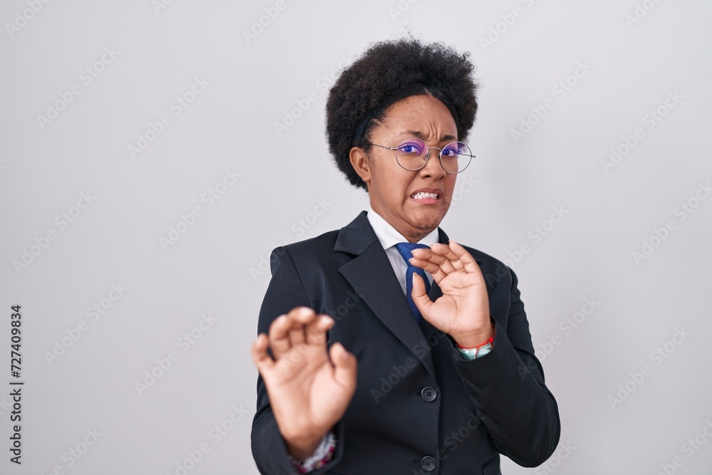 Beautiful african woman with curly hair wearing business jacket and ...