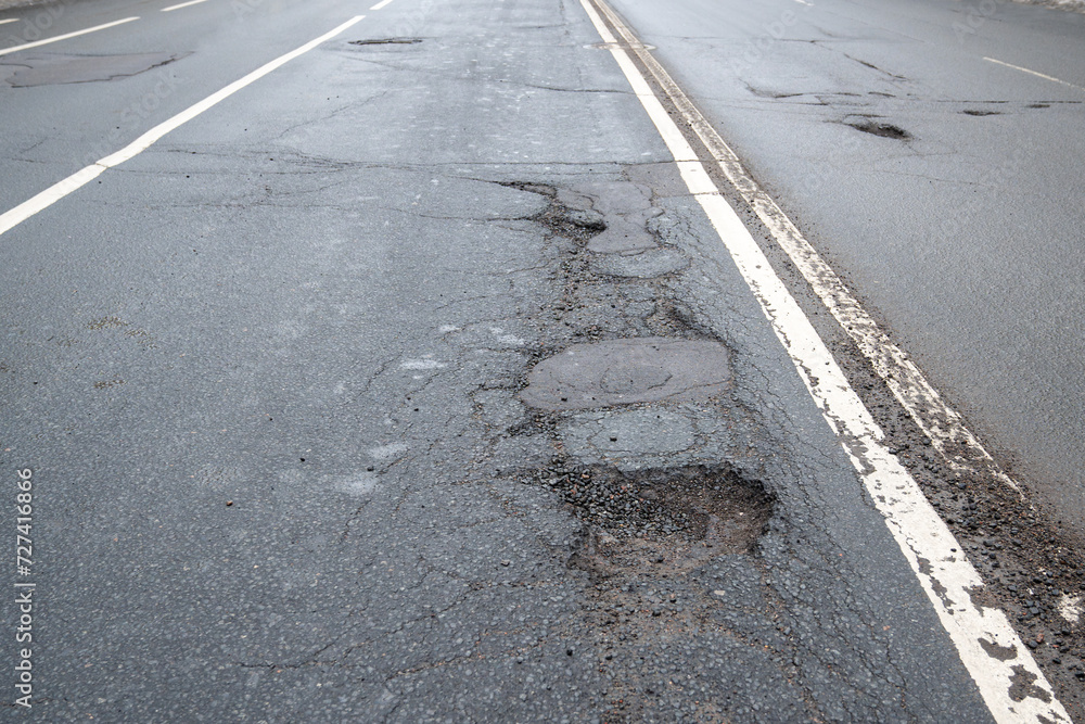 Broken asphalt road in city and untimely repair. Pothole asphalt with ...