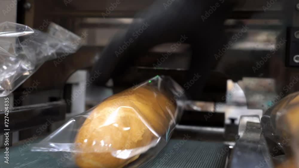 Fresh Bread Being Wrapped in Clear Packaging Film at Bread Packaging ...