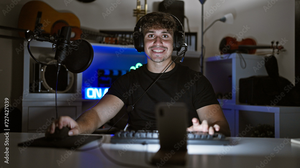 Attractive young hispanic man, a charismatic gamer, streaming overnight ...