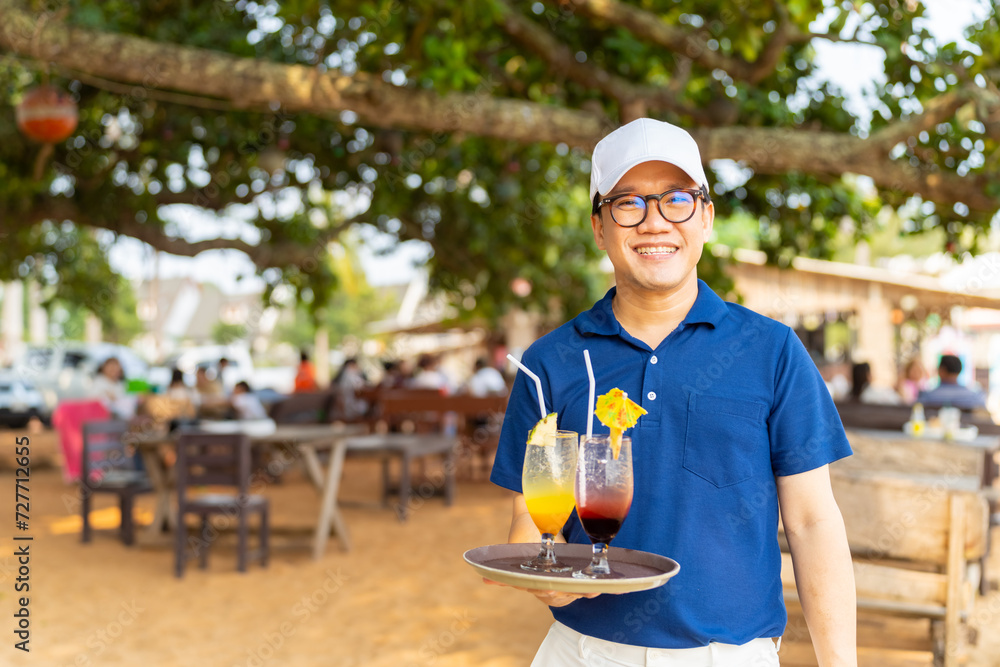 Portrait of Asian man waiter serving food and drink to customer on the ...
