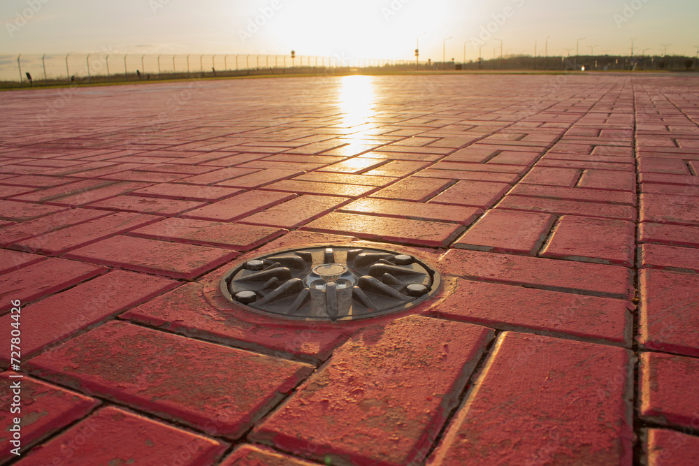 Helicopter pad. A red landing area for helicopters at sunset..Helipad ...