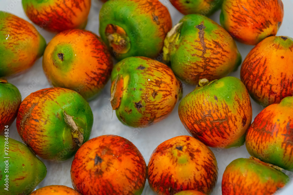 Rare and exotic fruit of the peach palm (Bactris gasipaes), typical ...