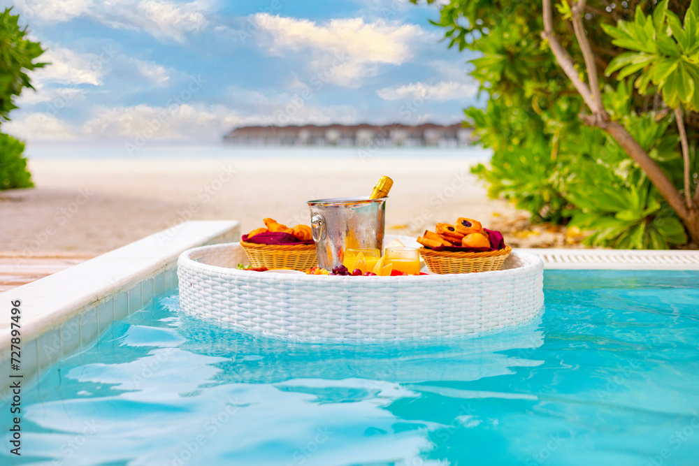 served floating tray in swimming pool with drinks and snacks on ...