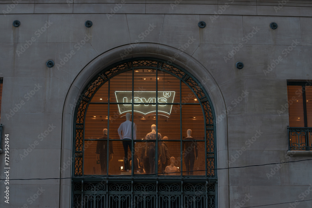 glance up at darkish window of a major department store featuring ...