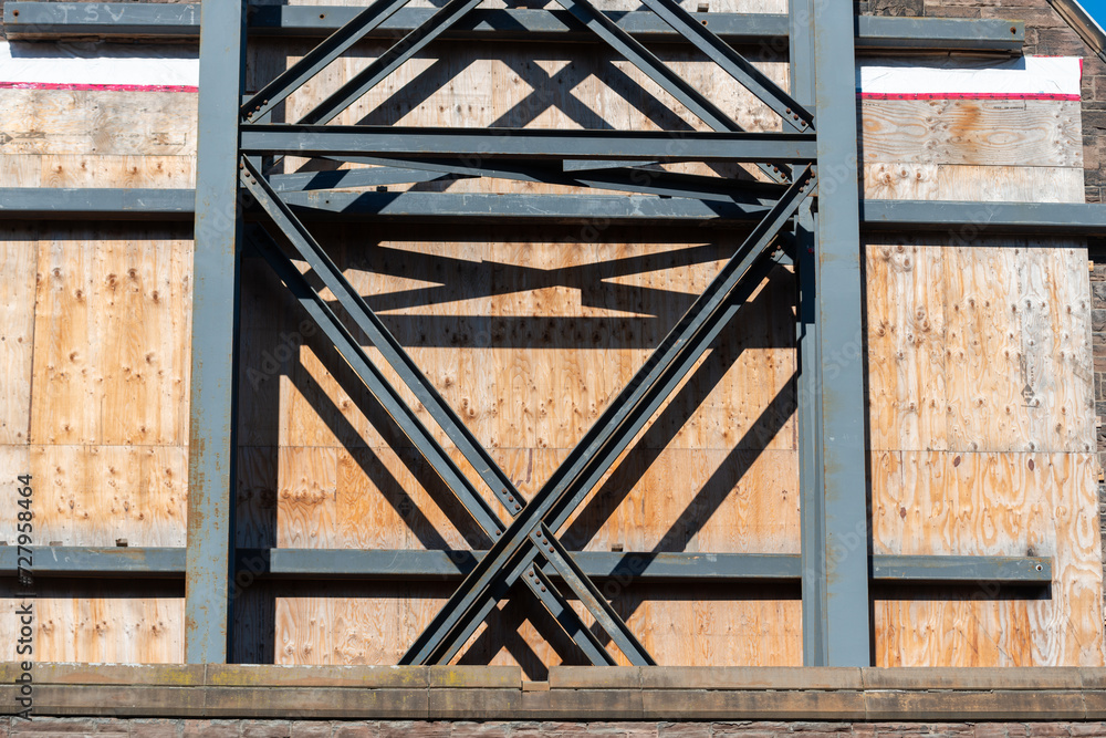 structural elements and plywood with sharp shadows at a construction ...