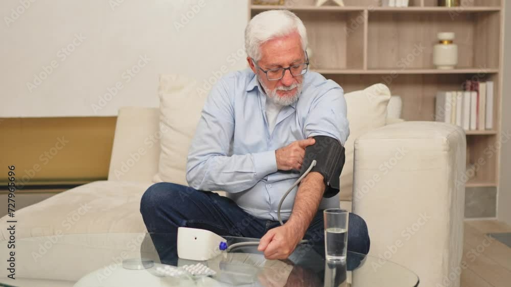 Hypertension problem in senior age. Old man measuring blood pressure ...