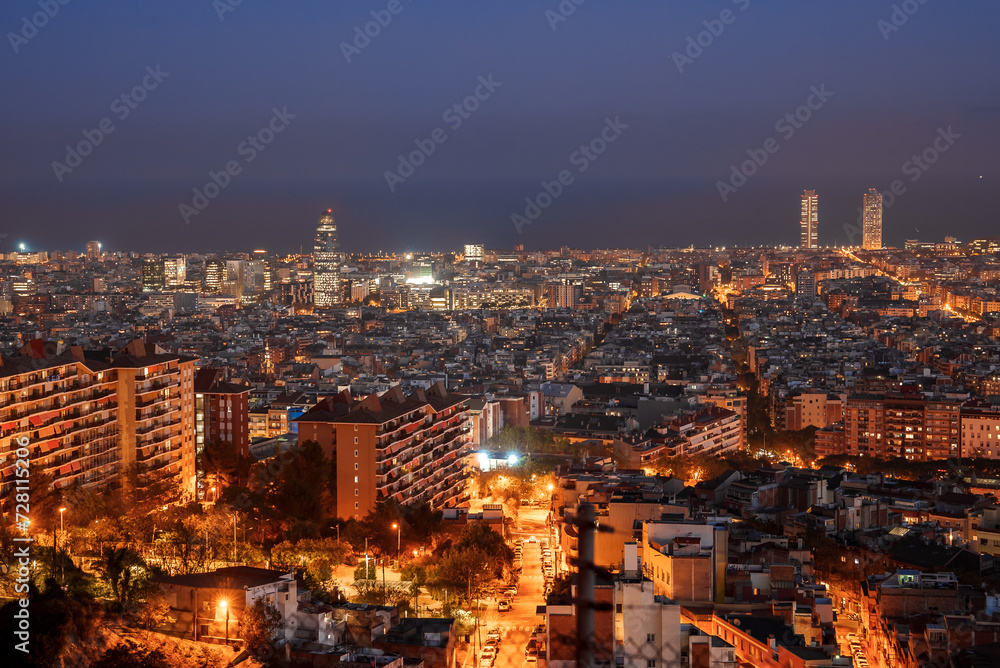 Panoramic night view of Barcelona, Spain, with glowing windows, a ...