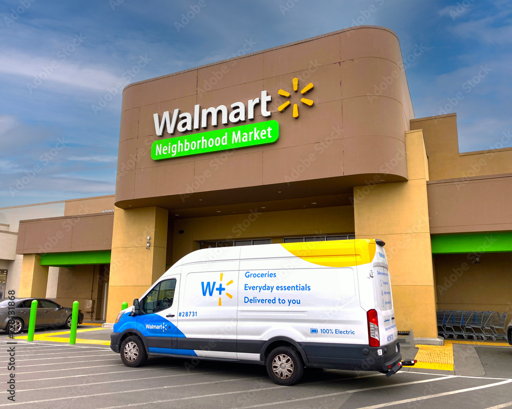 Exterior view of Walmart Neighborhood Market with a electric W+ ...