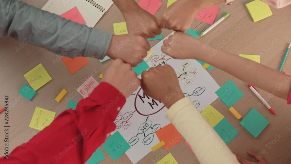 Professional diversity business group putting their hands together ...