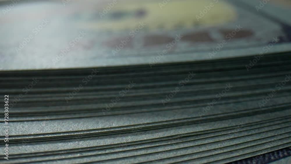 A macro view of a stack of American 100 dollar bills, rich in detail ...