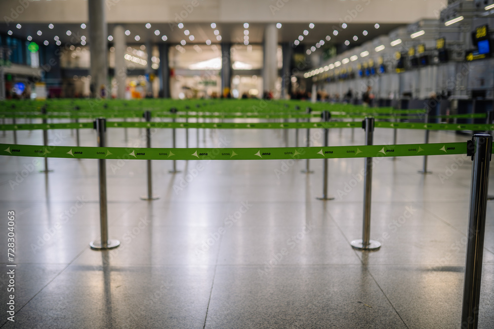 Malaga, Spain - January 28, 2024 - Queue barrier tapes at an airport ...
