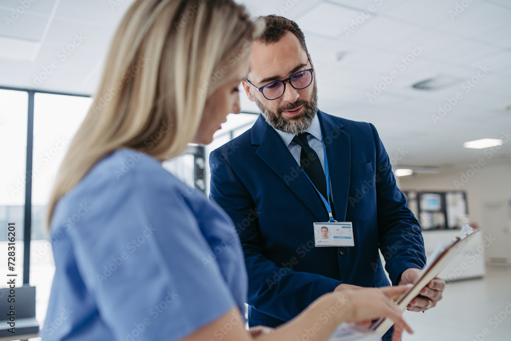 Pharmaceutical sales representative talking with doctor, presenting new ...