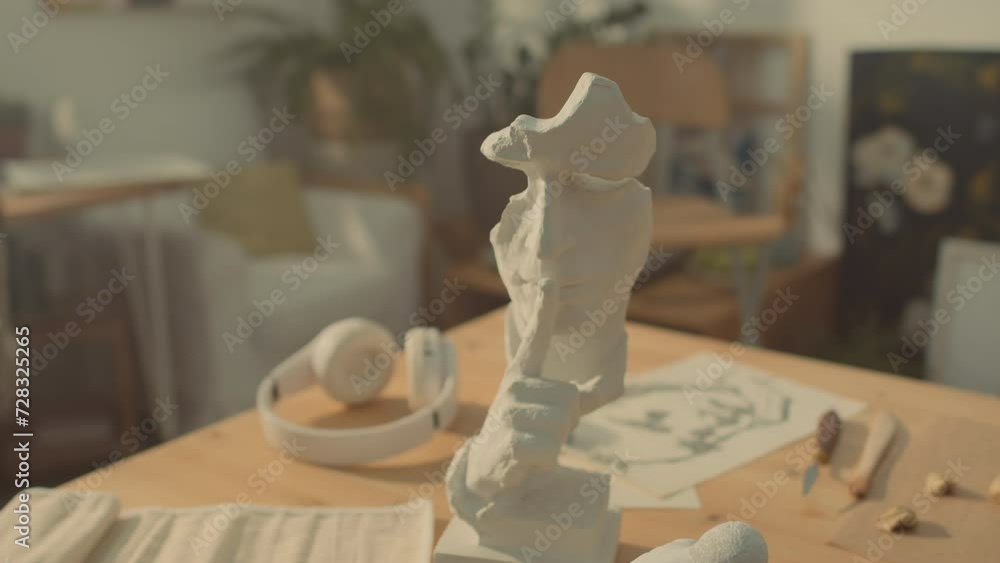 Close-up arc shot of abstract alabaster sculpture of human face with ...