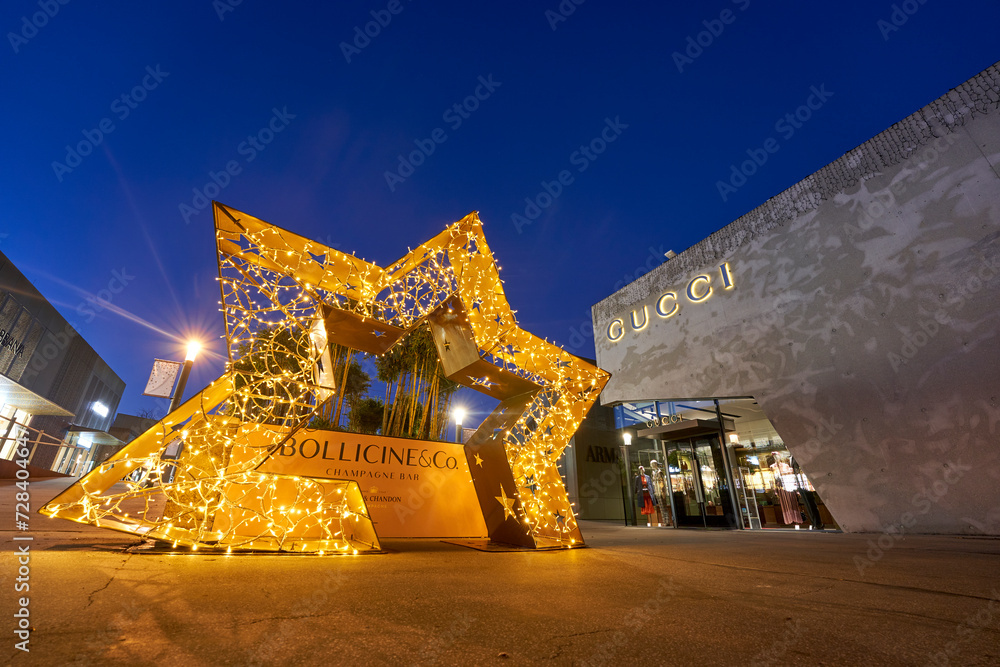 Gucci building in the outlet city. Illuminated company building with ...