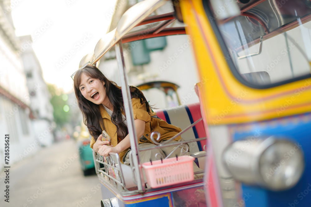 Attractive beautiful tourist woman or traveler woman sitting on tuk tuk ...