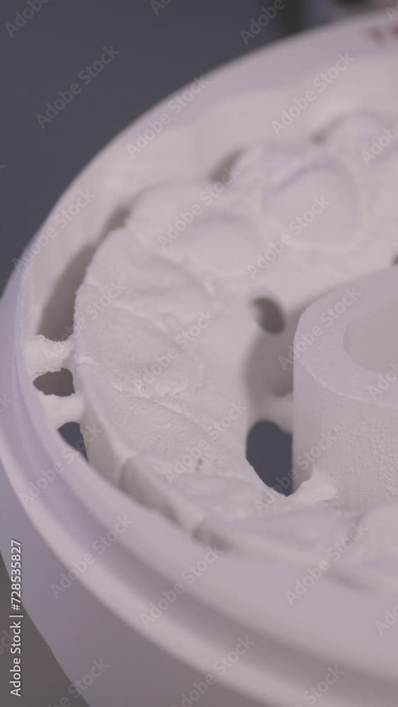 Vertical video. Close up. The shape of the artificial teeth is made on ...