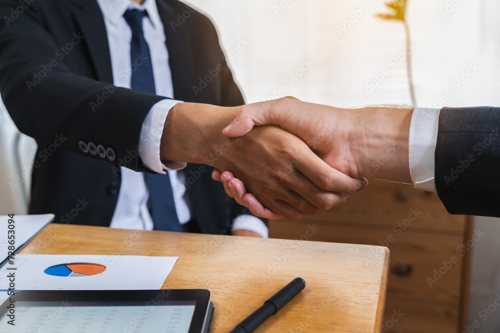 client and banker shaking hands on the meeting table after business ...