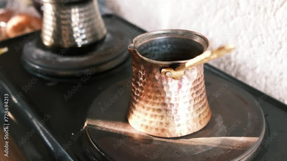 Vidéo Stock Making Turkish coffee in a traditional copper cezve over ...