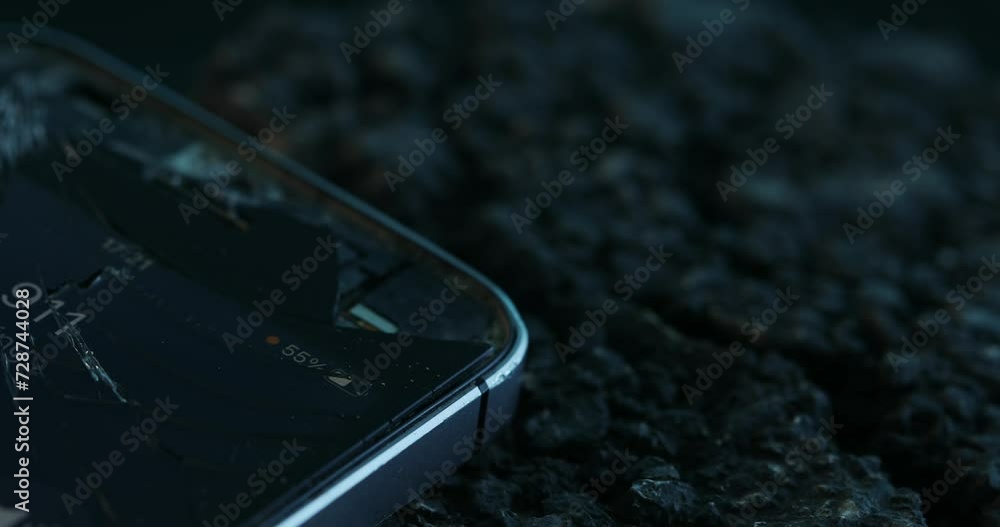 An urgent 911 call lights up the cracked screen of a smartphone on the ...