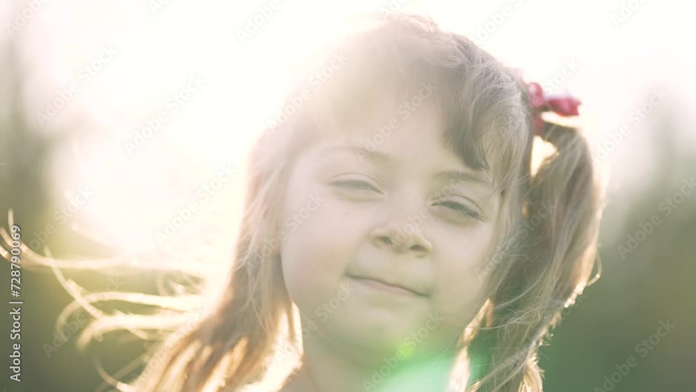 Vidéo Stock Happy girl in the sun in wind. Close-up of the girl face in ...