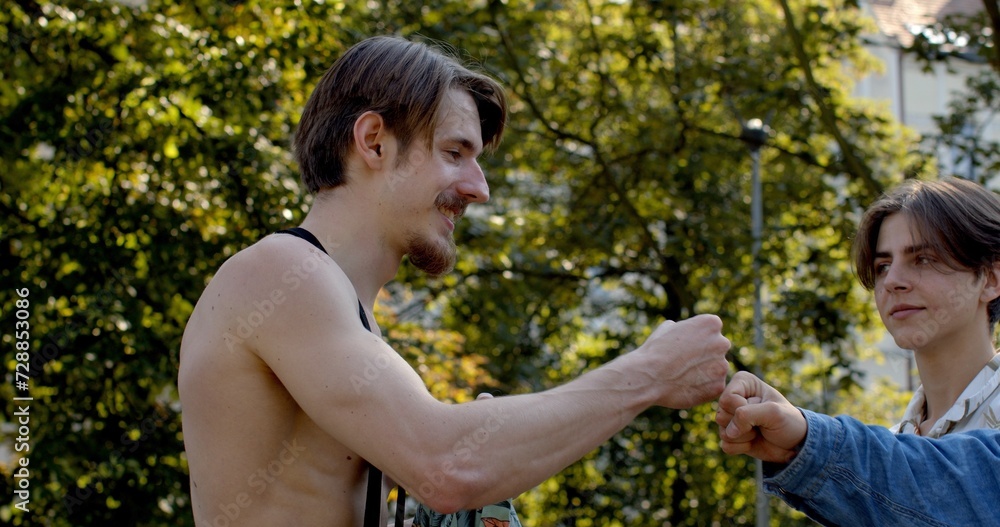 A muscular guy may use fist bumps with swagger as a way to express his ...