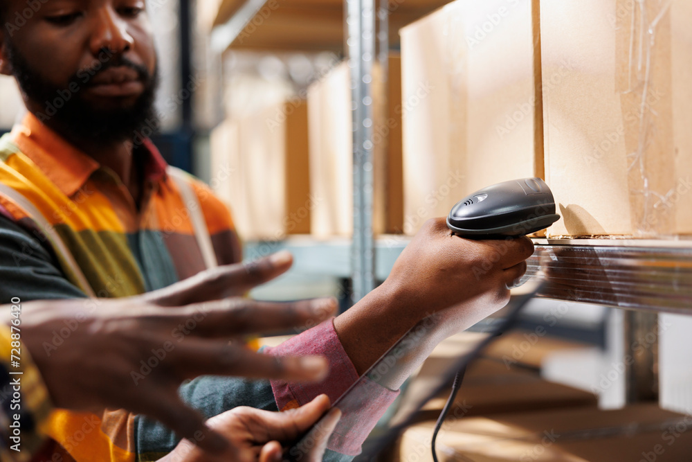 Delivery service employees checking cardboard box qr code in warehouse ...