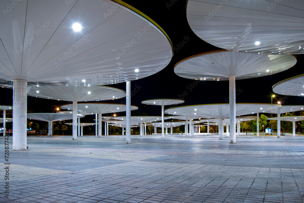 Plaza nocturna con estructuras circulares iluminadas Stock Photo ...