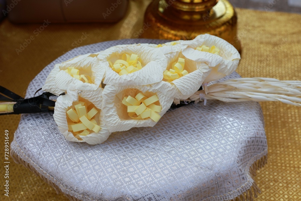 Sandalwood flowers made from paper are used in traditional Buddhist ...